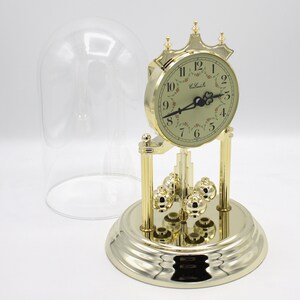 Vintage Anniversary Clock Glass Dome Brass Tone Spinning Weight Pendulum Analog Electric Quartz ...
