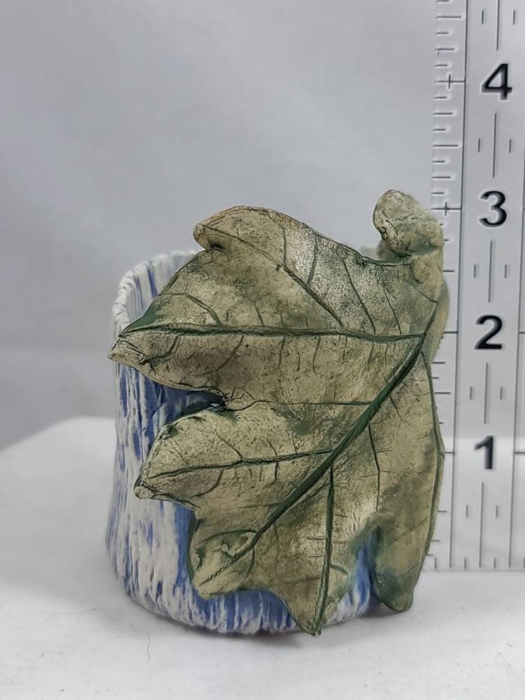 Adorable Little Pot With Olive Green Oak Leaf Upon a Slate Blue ...