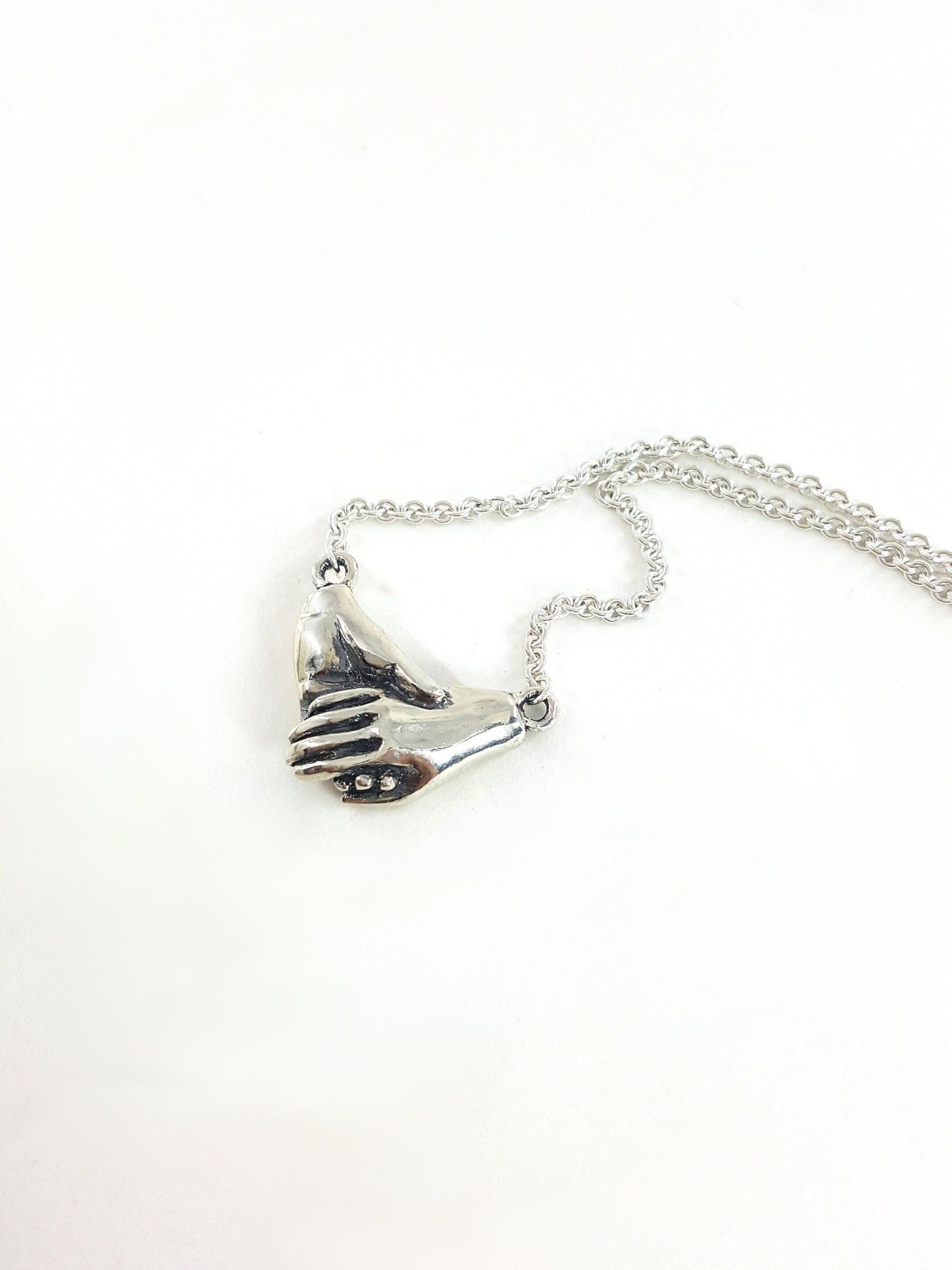 Holding hands necklace store