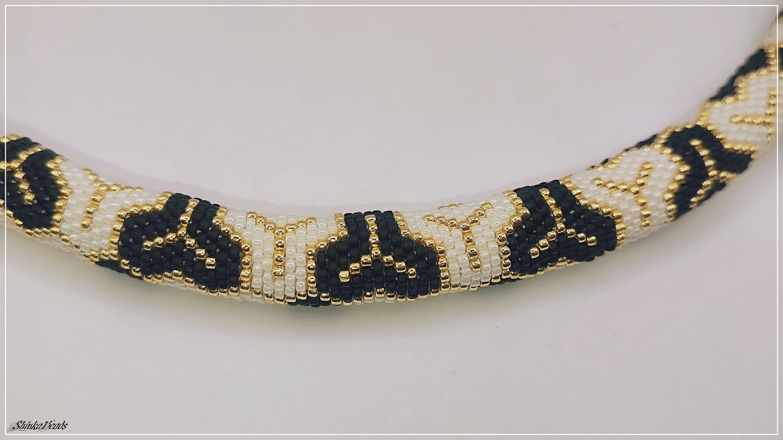 White, Black, and Golden Geometric Pattern Necklace, Ornamented Bead ...