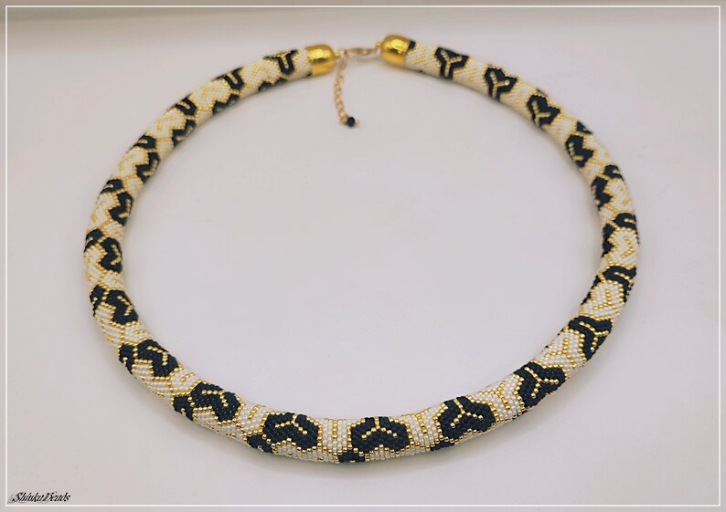 White, Black, and Golden Geometric Pattern Necklace, Ornamented Bead ...