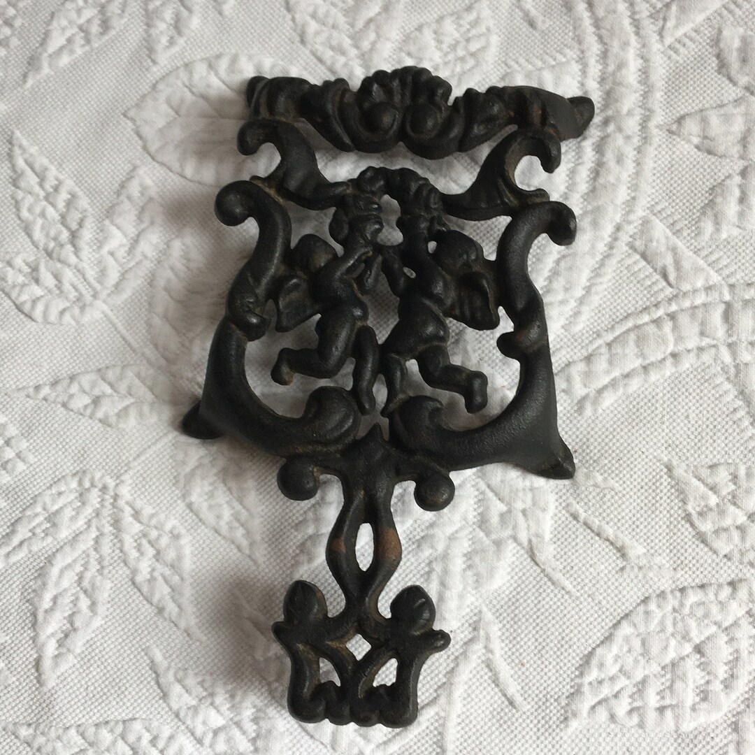 Vintage Cast Iron Cupids Trivet With Four Legs. Sits on Four Legs or ...