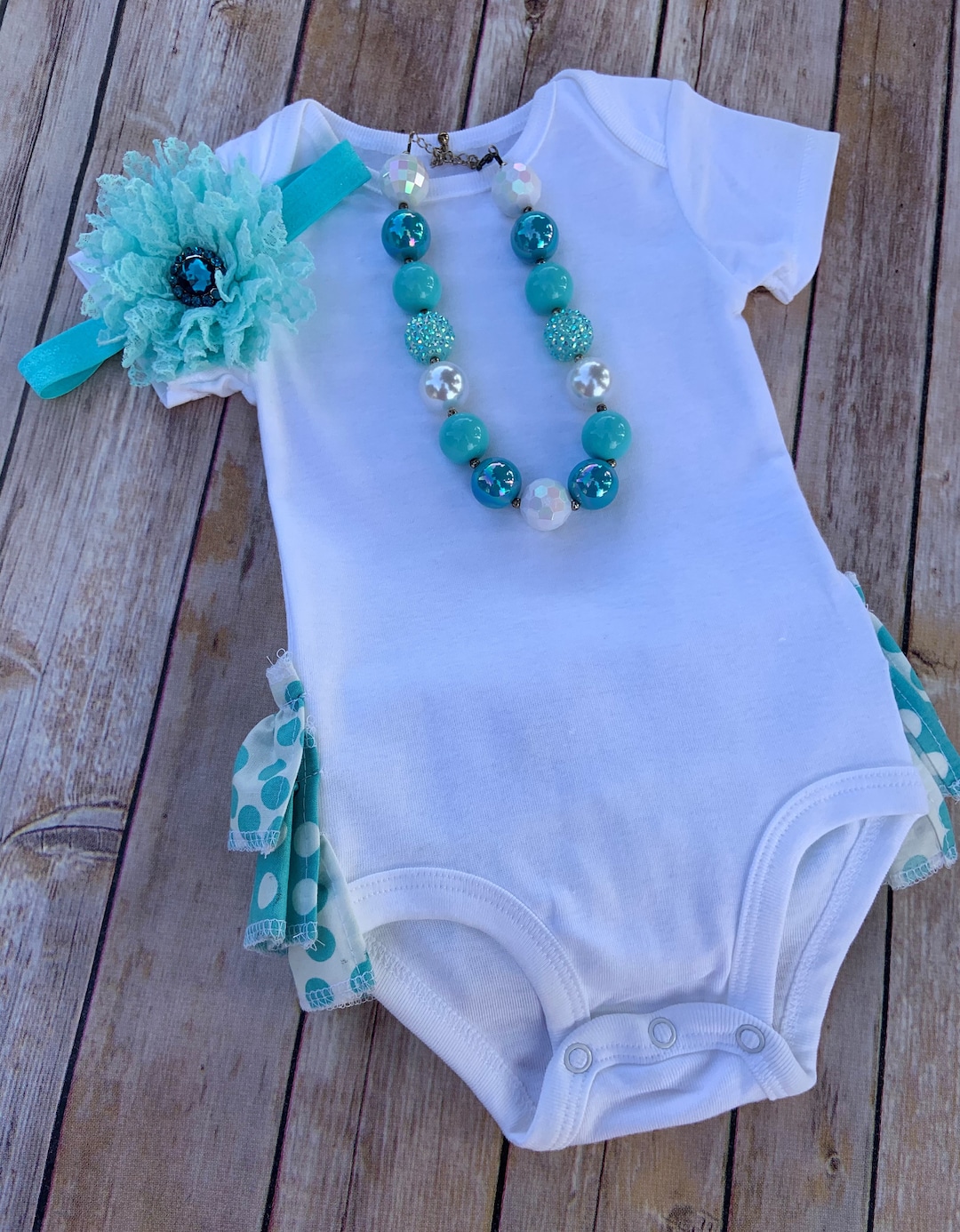 Aqua, White, and Turquoise One Piece Outfit with Ruffles on the Back ...