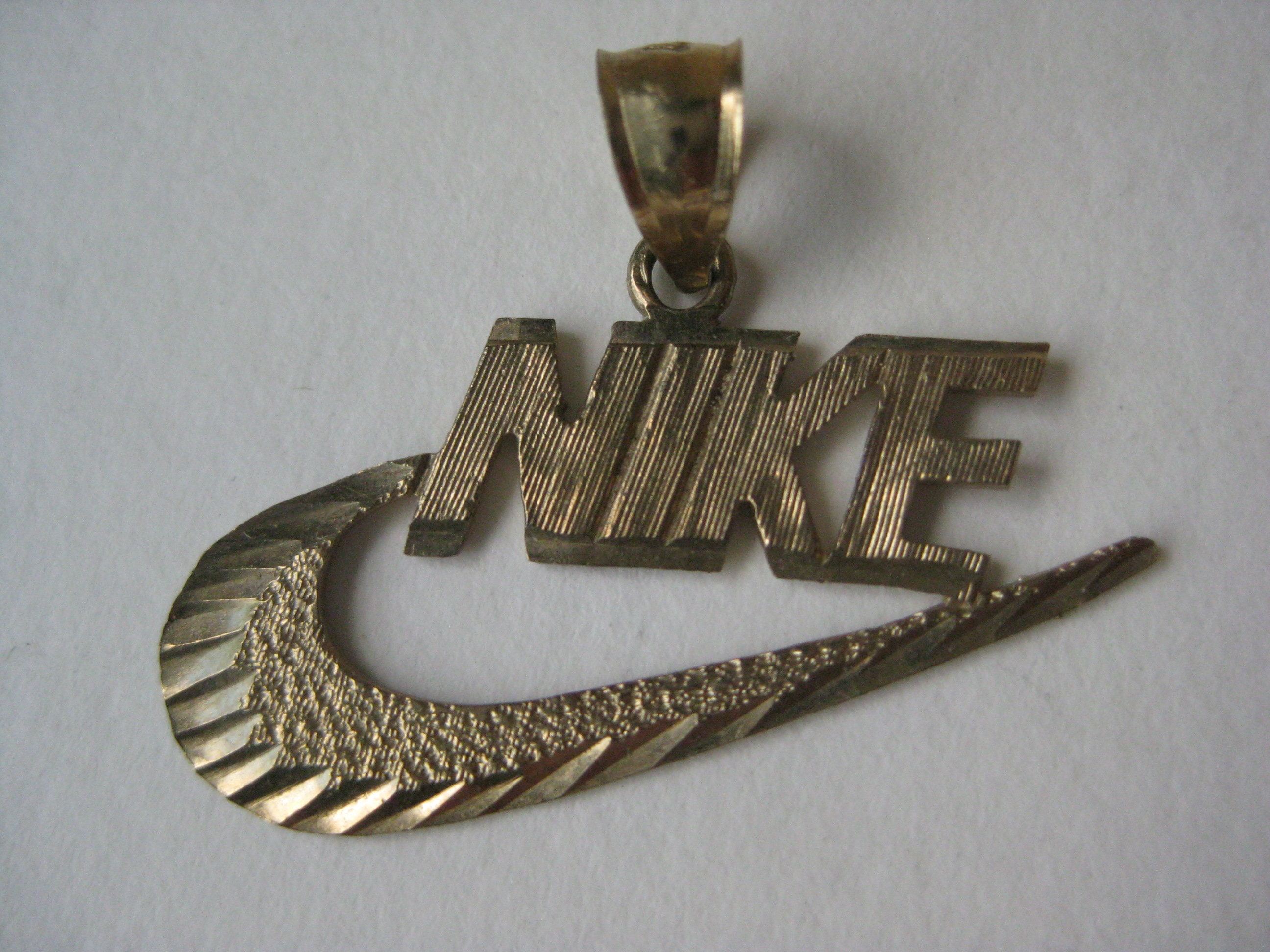 Gold Nike Swoosh