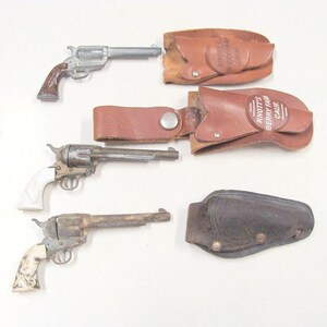 Three Vintage Toy Miniature Revolver Cap Pistols in Leather Holsters ...