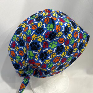 DOG Tie Back Pixie Hat, With Bones and Paws on Royal Blue Background ...