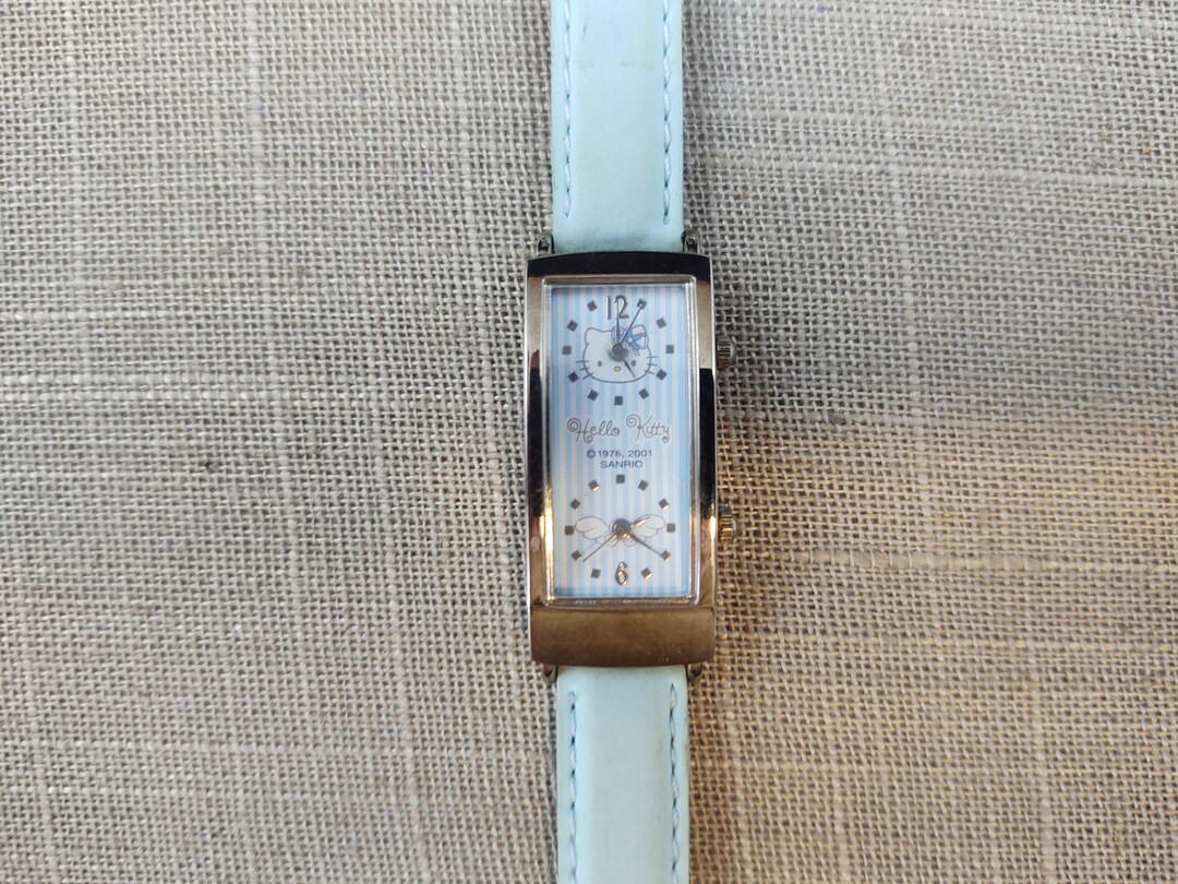 Hello Kitty Double Face Watch, by Sanrio, Blue Stripes on Face and Light Blue Faux Leather Strap ...
