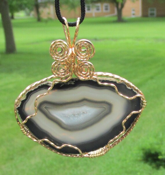 Items similar to Agate Geode Slice pendant wrapped in Bronze wire on Etsy