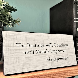 The Beatings Will Continue Until Morale Improves Sign, Book Shelf ...
