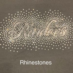 Cursive Raiders With a Firework Splash Around It Rhinestone Bling Shirt ...