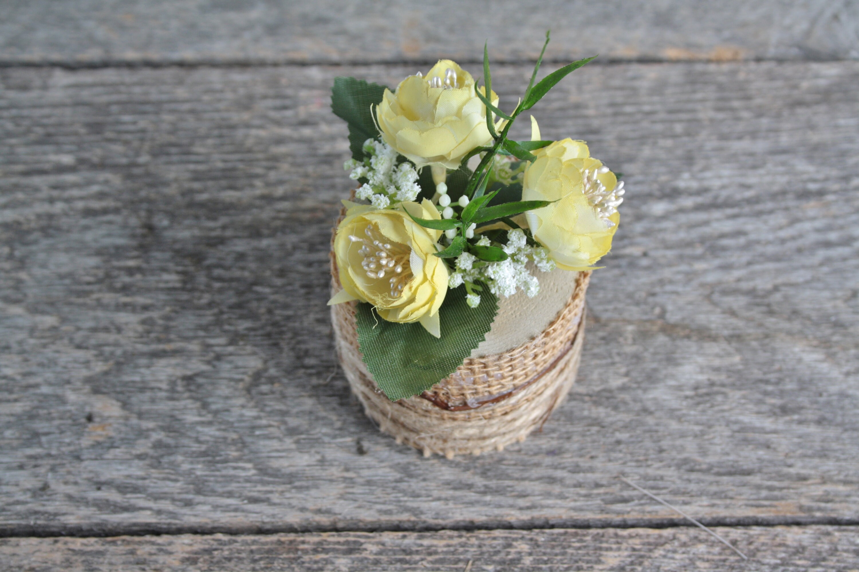 Flower arrangement on small log of wood decorated with cedar | Etsy