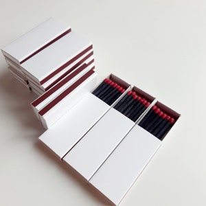 25 White Plain Matchboxes, Filled With Black Wooden Sticks With Bordo ...