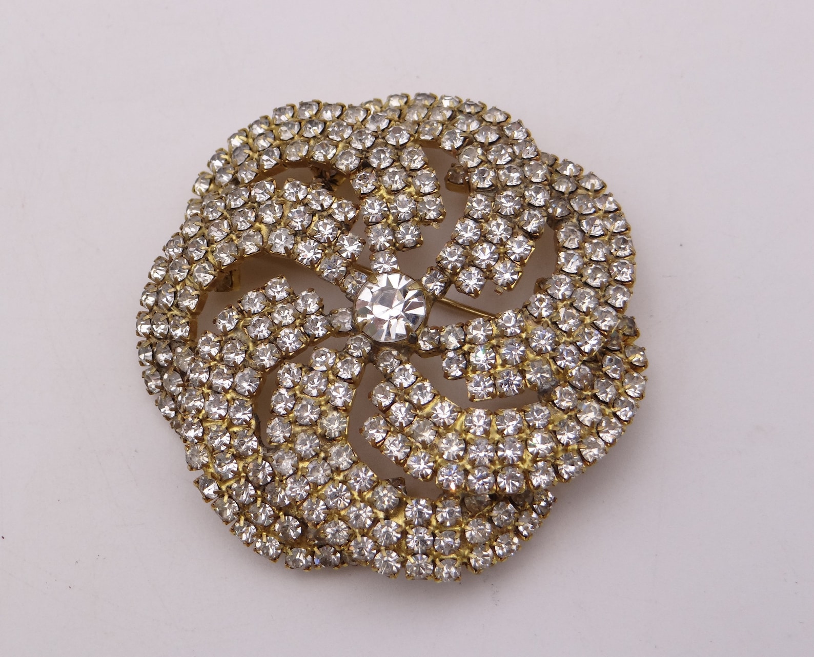 Vintage Rhinestone Swirl Brooch With Large Center Rhinestone on a Gold ...
