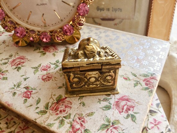 Antique brass postage stamp box with cherub face - Gem