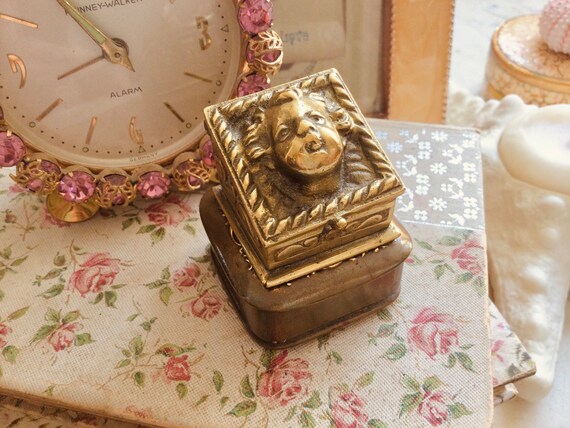 Antique brass postage stamp box with cherub face - Gem