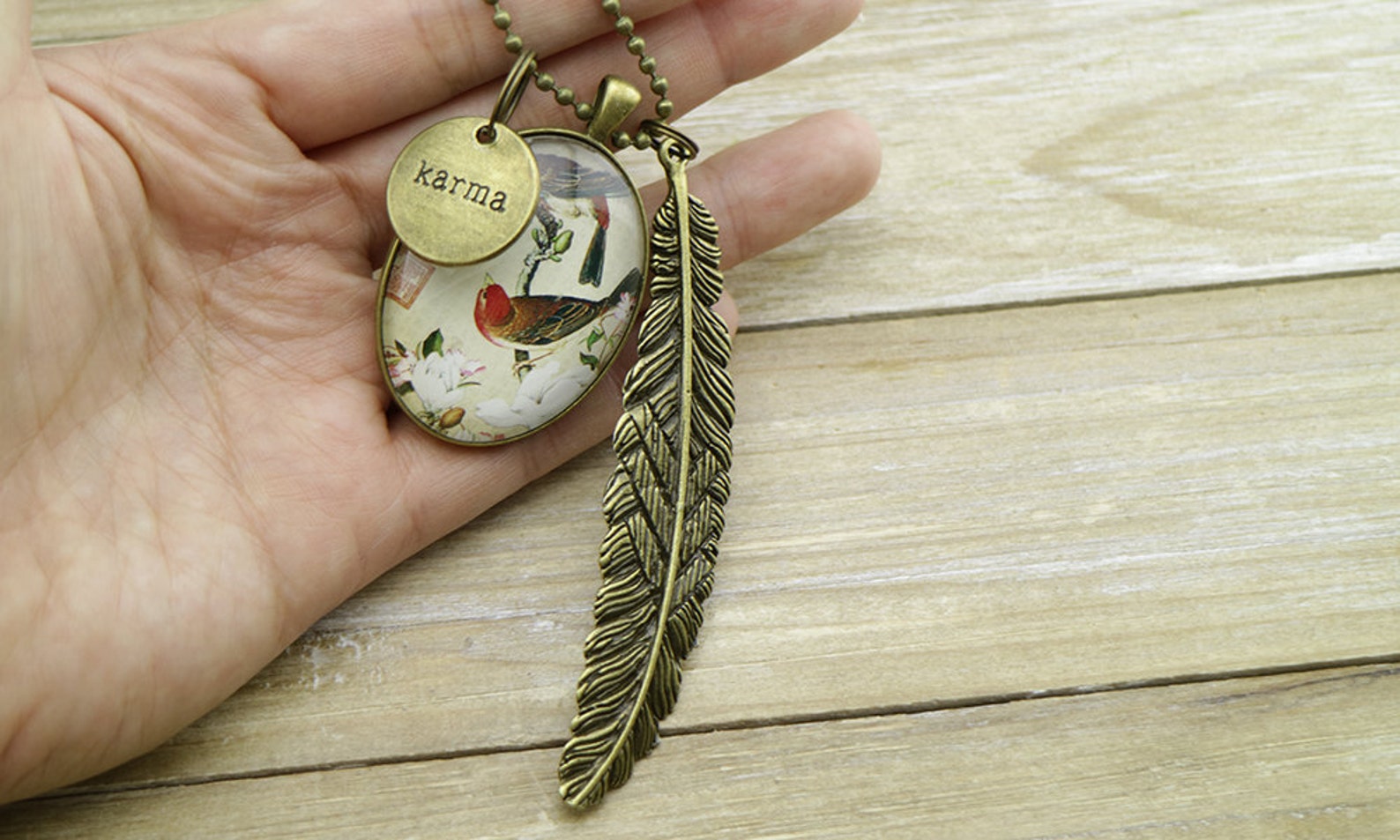 Oriental Bird Oval With Bronze Feather and Karma Charms on a - Etsy