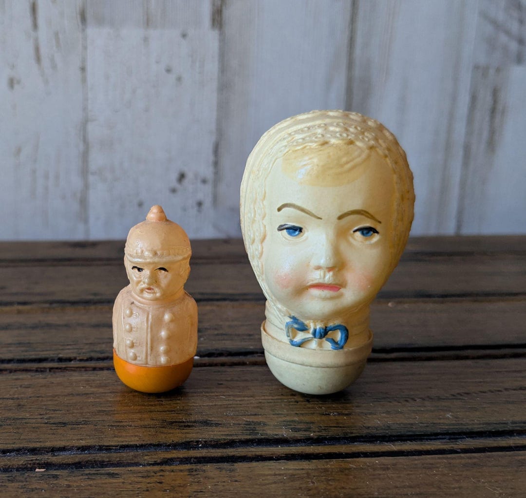 Two Tiny Roly Poly Celluloid Toys, Policeman & Doll Head, Weighted ...