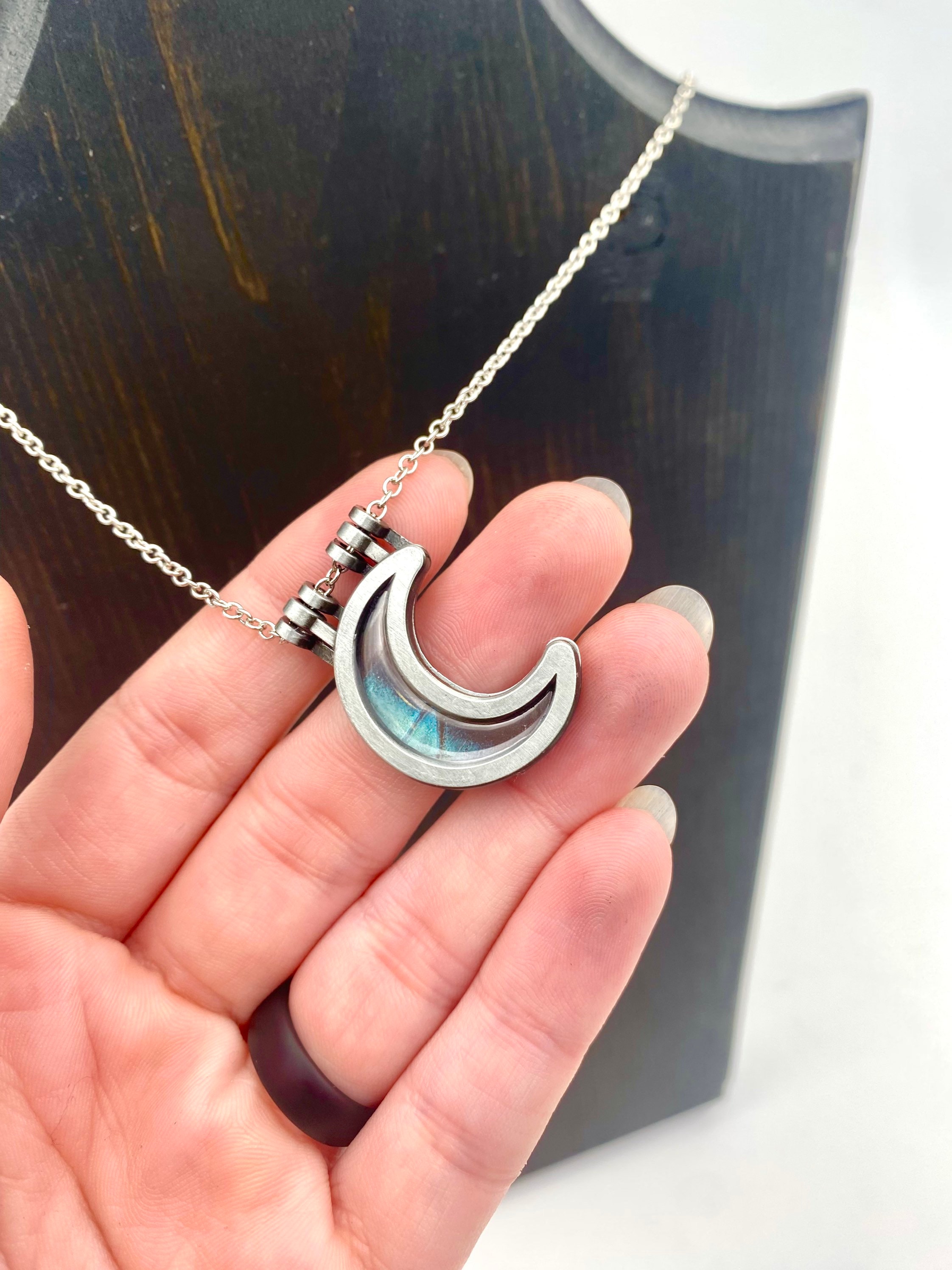 Moon shaped locket with professionally preserved black banded blue ...