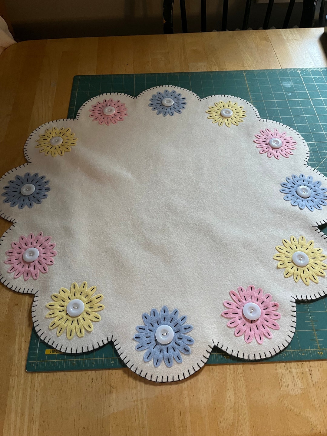 Flower Candle Mat With an off White Background and Pink, Blue and ...
