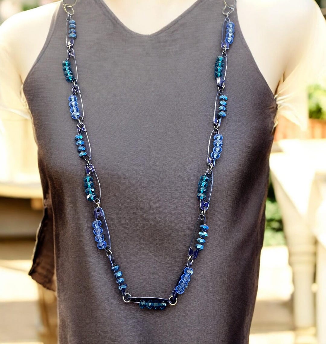 This the Unique Combination of Dark Metal Safety Pins and Vibrant Blue ...