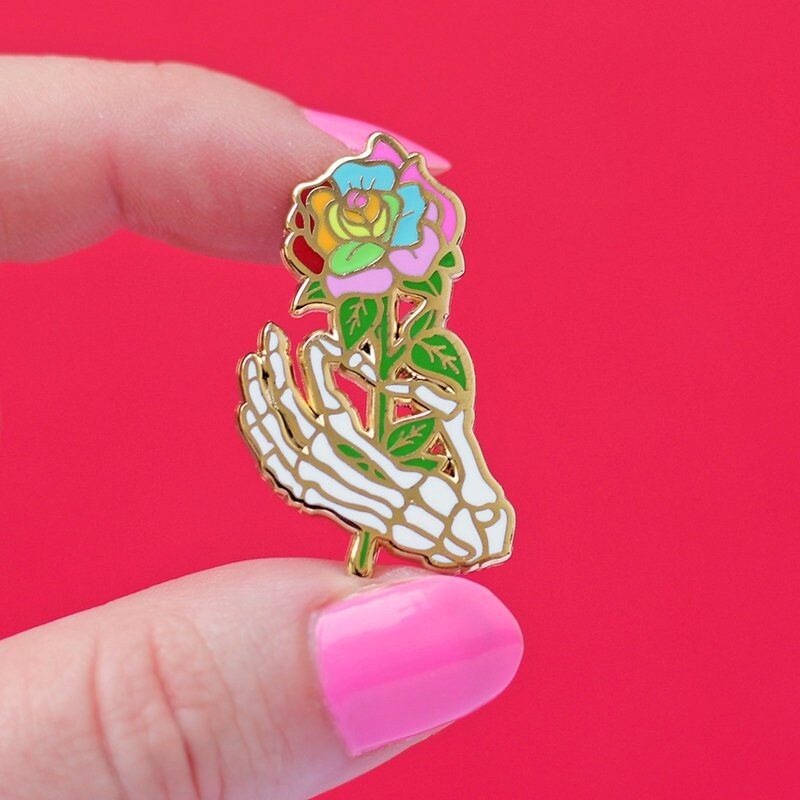 Skeletal hand holding a rainbow rose enamel pin bones | Etsy
