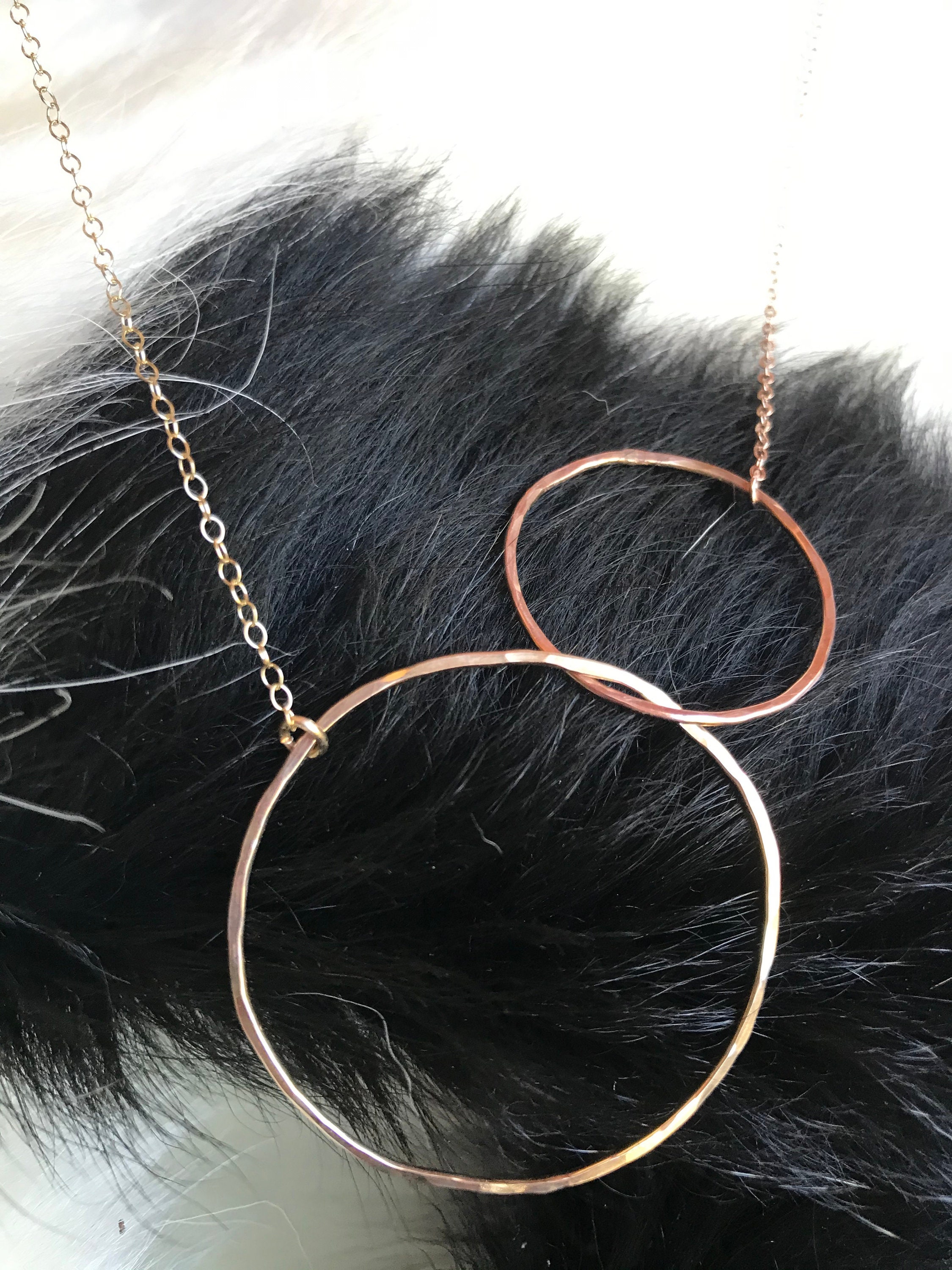 The Lydia necklace is two interlocking circles, one 14k gold fill and ...