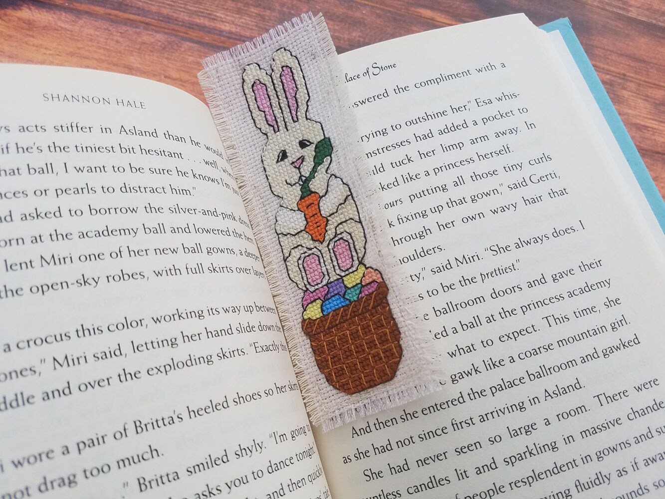 Bunny Sitting on a Basket of Easter Eggs and Holding a Carrot Cross ...