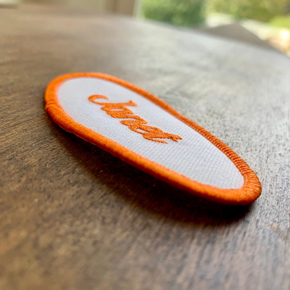 Janet. A white work shirt patch that says "Janet" in … - Gem