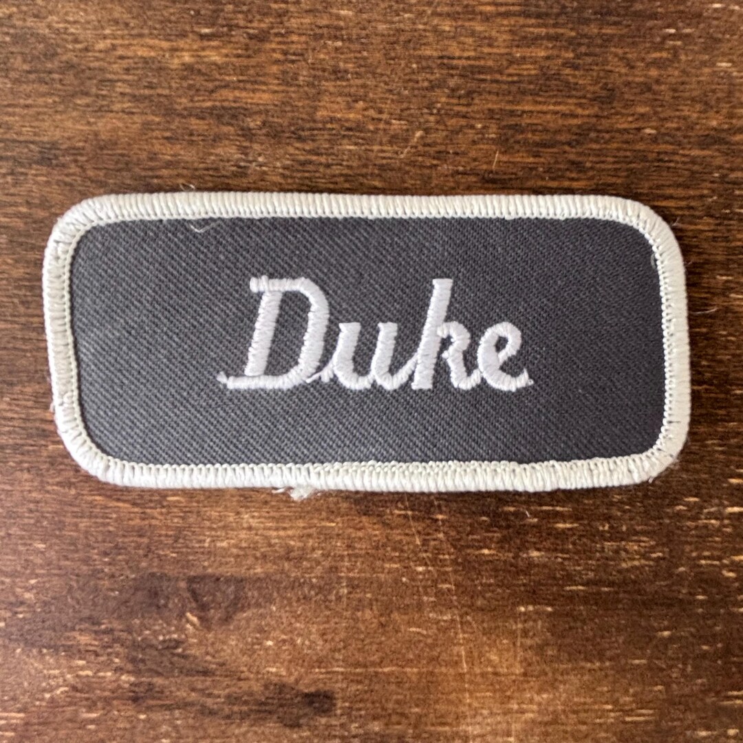 Duke. A Gray Patch That Says "duke" in White Script With White Border ...