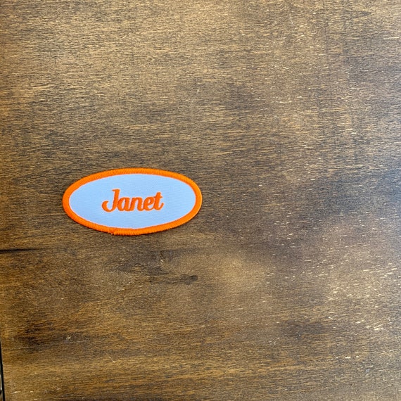 Janet. A white work shirt patch that says "Janet" in … - Gem