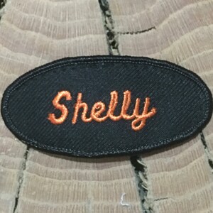Shelly. A Black Work Shirt Name Patch That Says shelly in Orange Script ...
