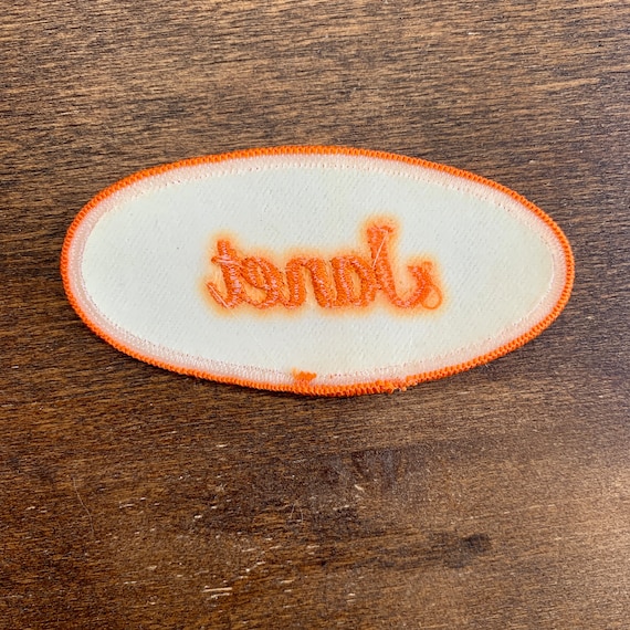 Janet. A white work shirt patch that says "Janet" in … - Gem