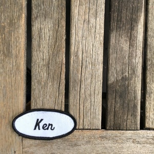 Ken, an off White Oval Work Shirt Name Patch That Says "ken" in Black ...