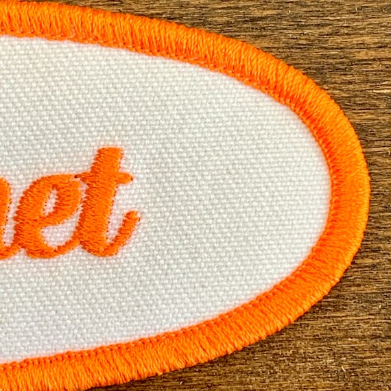 Janet. A white work shirt patch that says "Janet" in … - Gem