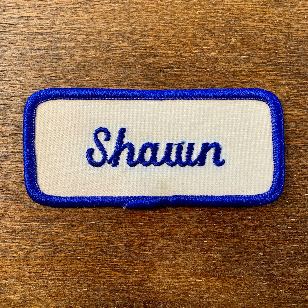 Shawn - A White Work Shirt Name Patch That Says "shawn" in Blue Script ...