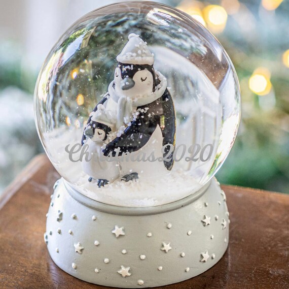 Hand Holding Snow Globe