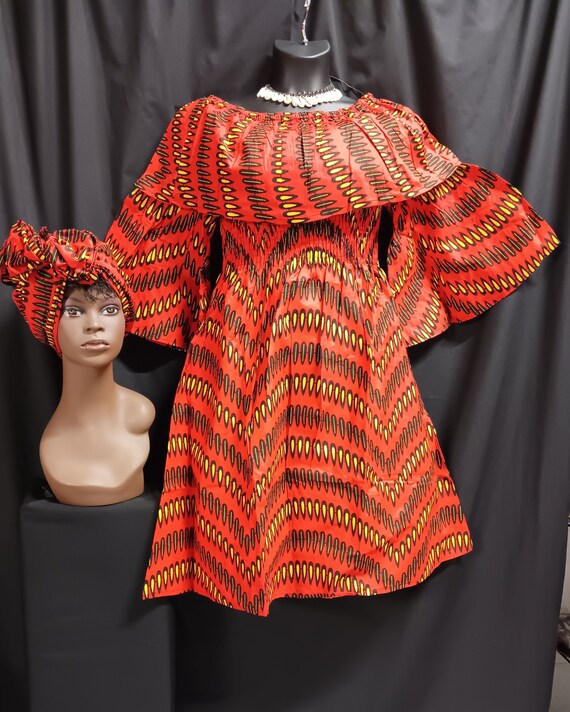 African print Dress. Over shoulder collar elastic top to waist pockets elbow length full sleeves mid length dress with matching headwrap
