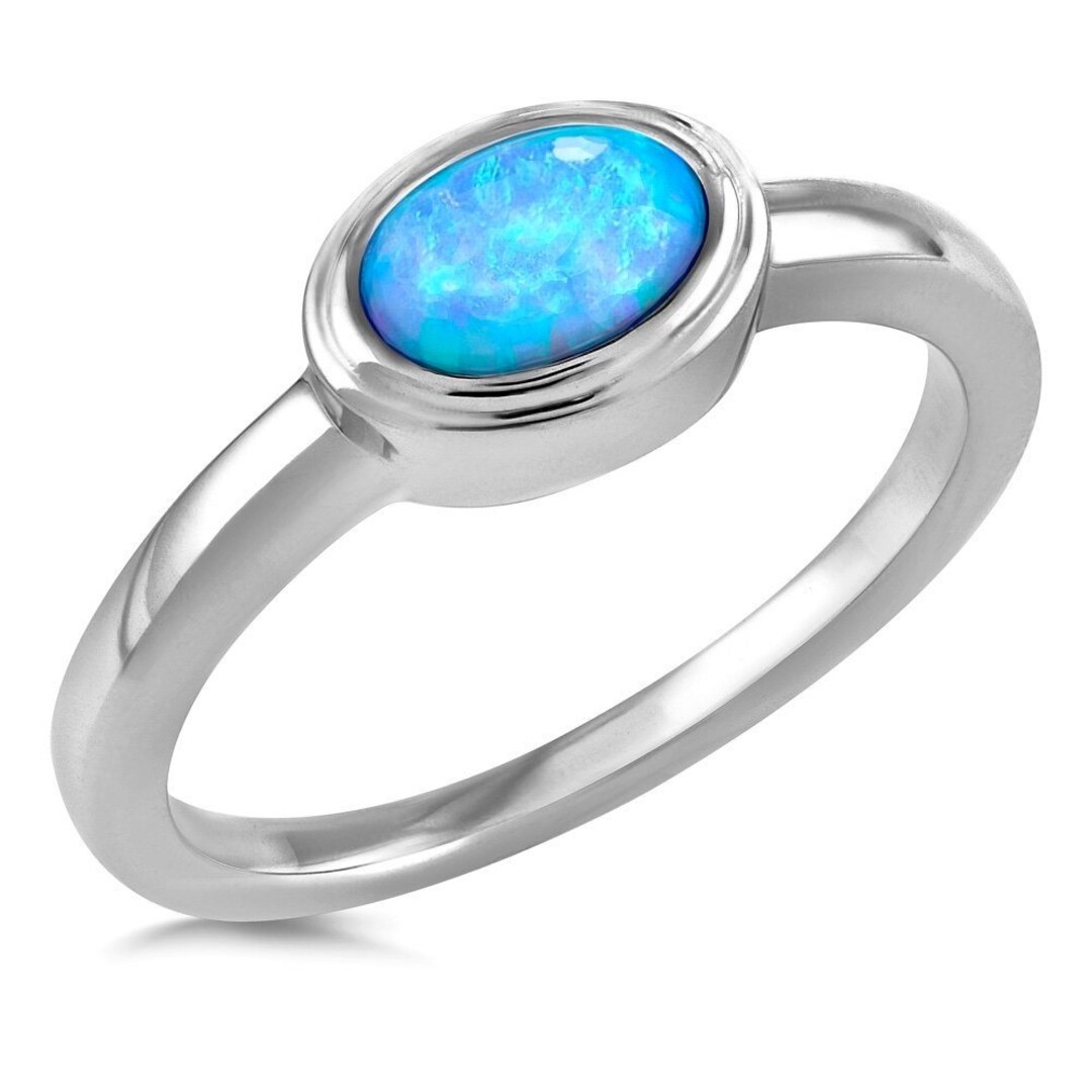 Vibrant Cultured Blue Opal Ring in a Low, Oval Rub Over Setting. Ref ...