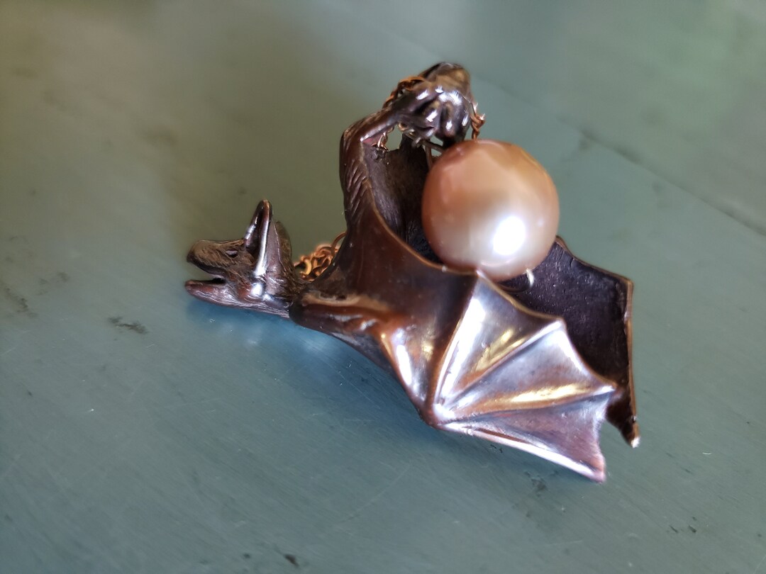 A Sleek Bob Burkett Shibuichi Bat Swooping by With Its Glowing Pearl ...