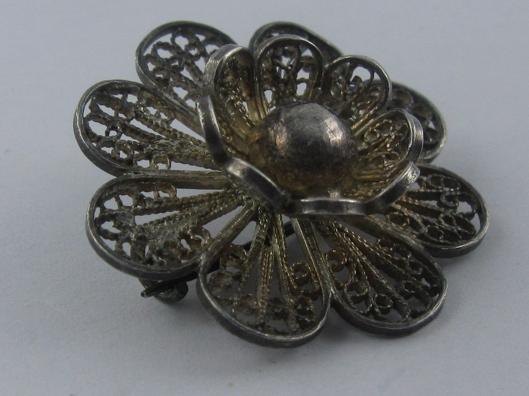 Flower Art: Ancient Brooch in the Shape of a Small Silver Flower ...