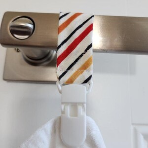 Towel Holder - Red, Yellow and Black Strips on White Background, Loop ...