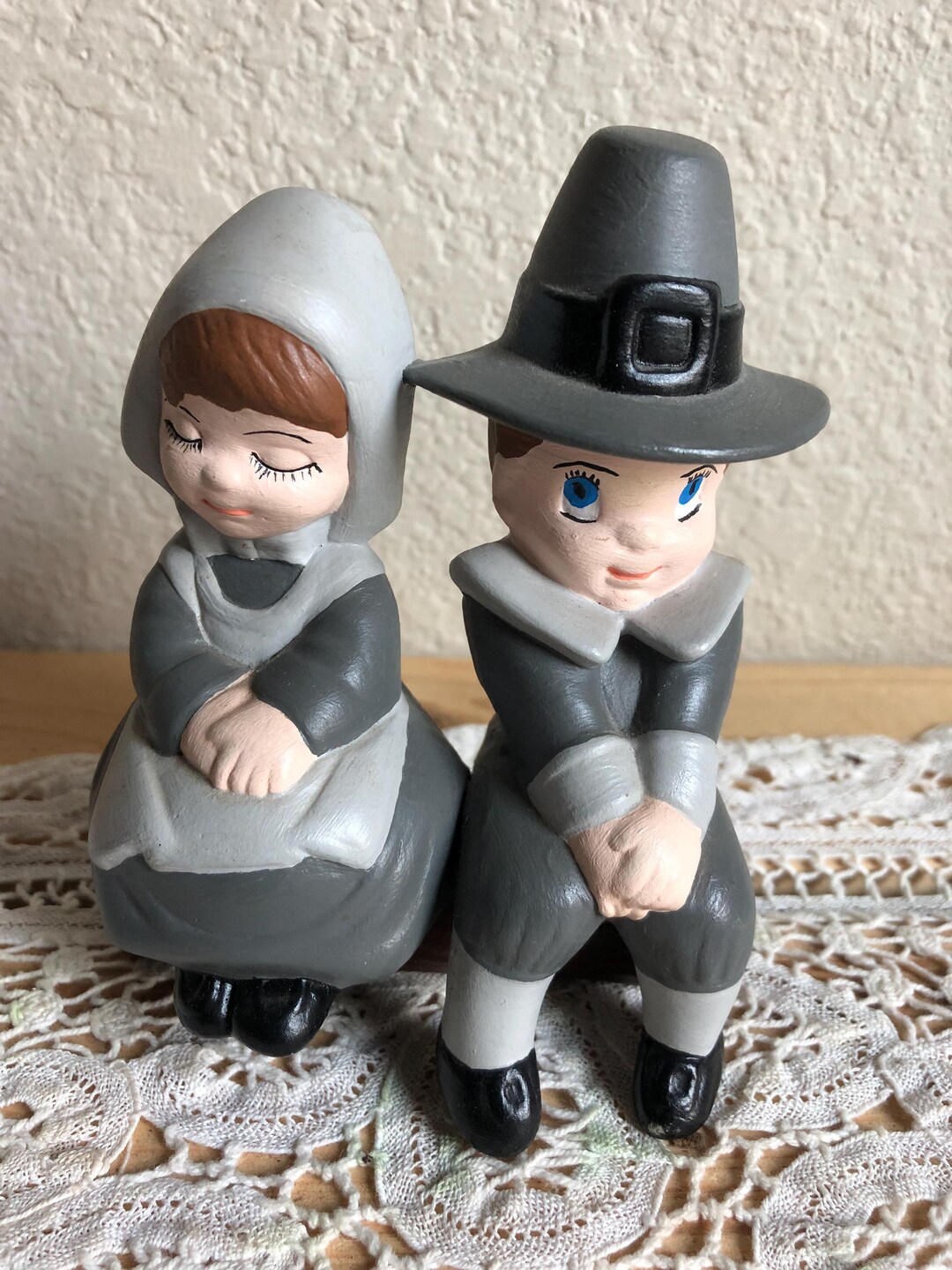 A Ceramic Figurine of A Couple With the Look of Pilgrims Resting on A ...