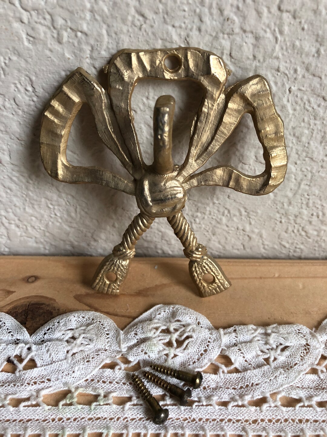 A Metal Shiny Gold Tone Wall Hook in the Shape of A Bow With Tassel ...