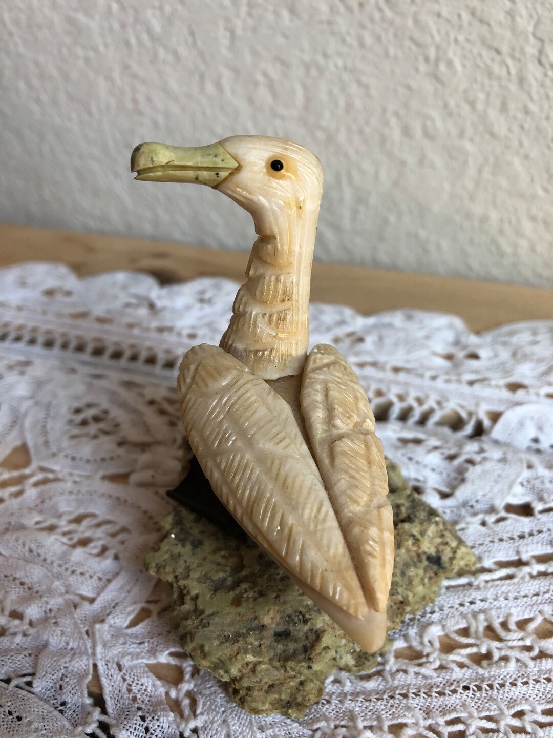 A Small Bird/seagull Sculpture Made From Shells Standing on A Rock With ...