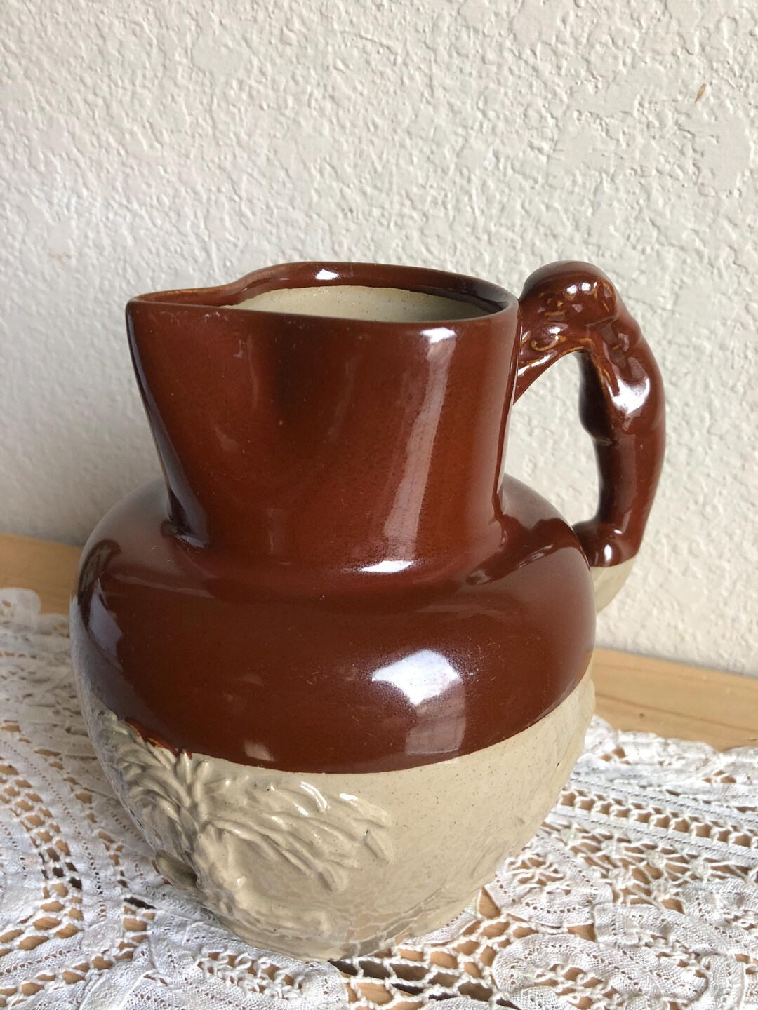 A Two Tone Stoneware Pottery Decorative Pitcher With Raised Designs ...