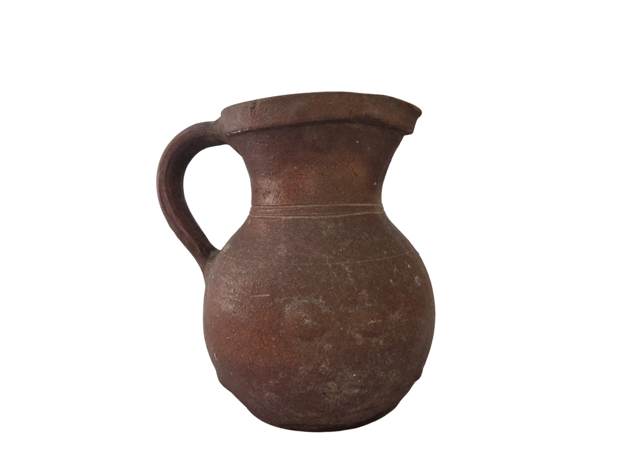Clay Pitcher Pouring Water