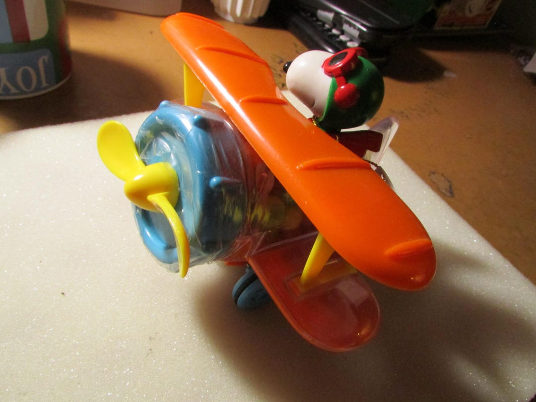 Snoopy Flying Ace Candy Container Bi-plane Peanuts Dog Airplane Orange ...