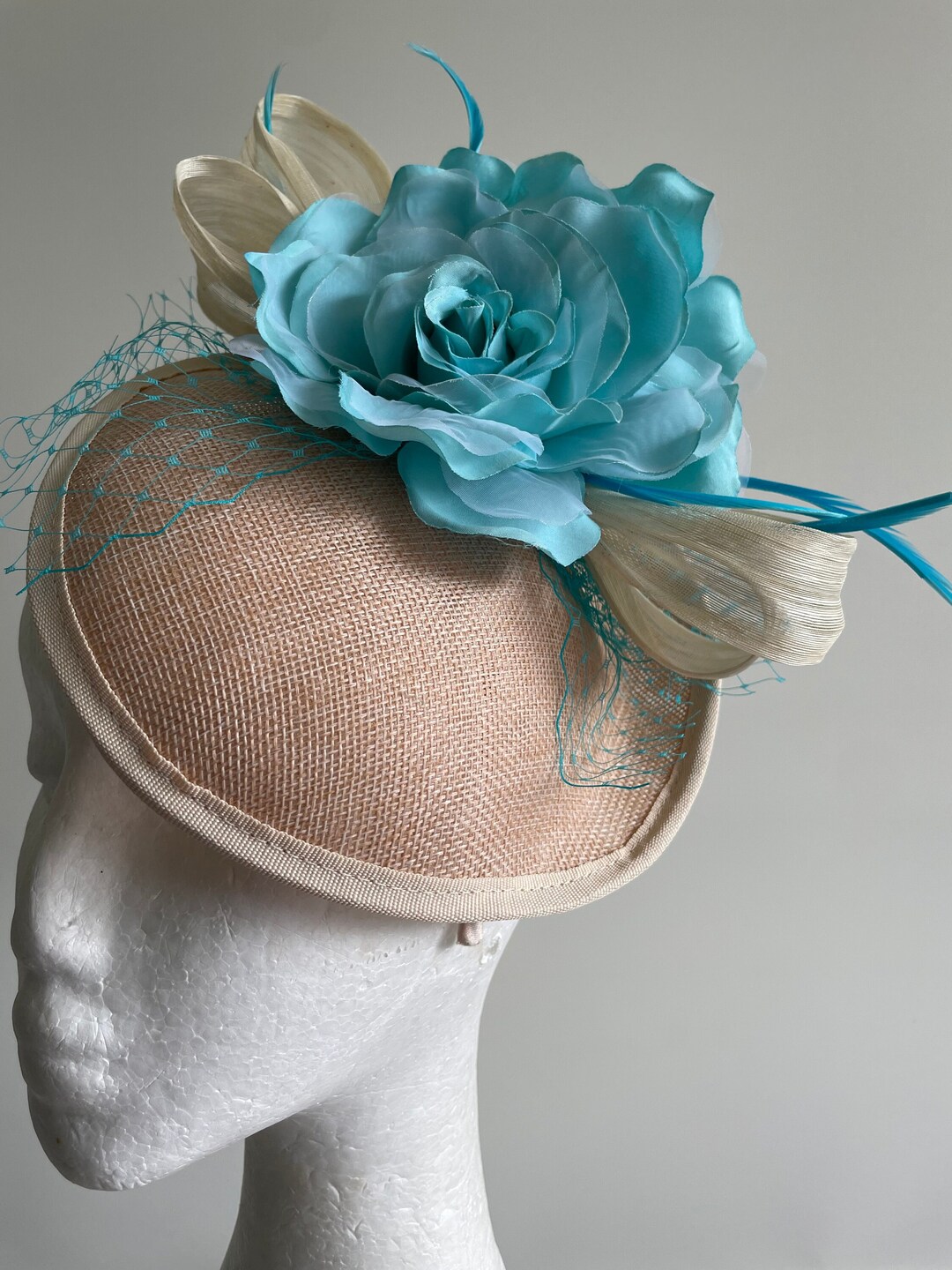 Cream Loop Fascinator With Blue Flowers, Feathers and Netting on a ...