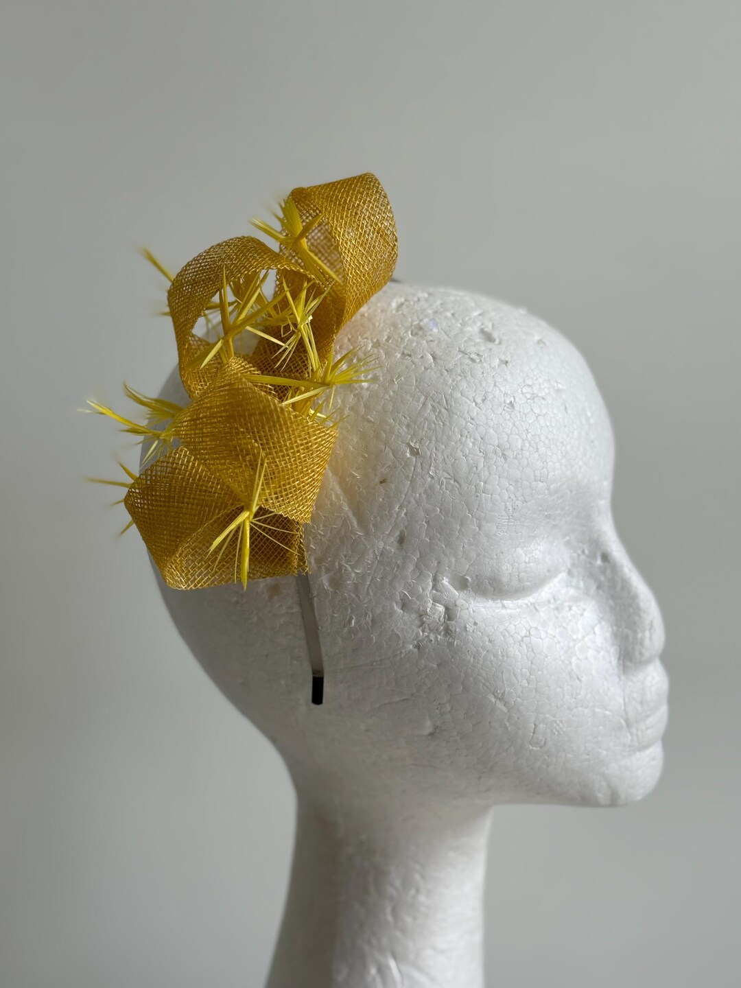 Yellow Sinamay Loop Fascinator With Biot Feathers on a Silver Metal ...