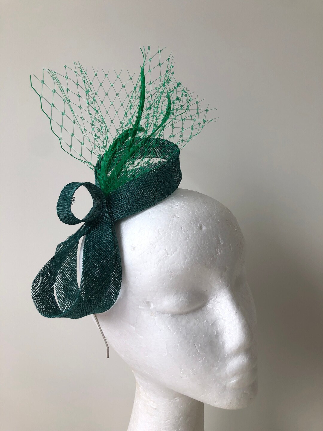 Emerald Green Loop Fascinator With Netting and Feathers on a Silver ...